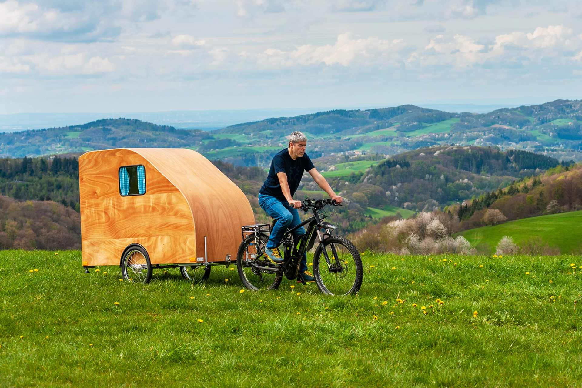 Deluxe wooden trailer is made to be towed by ebike