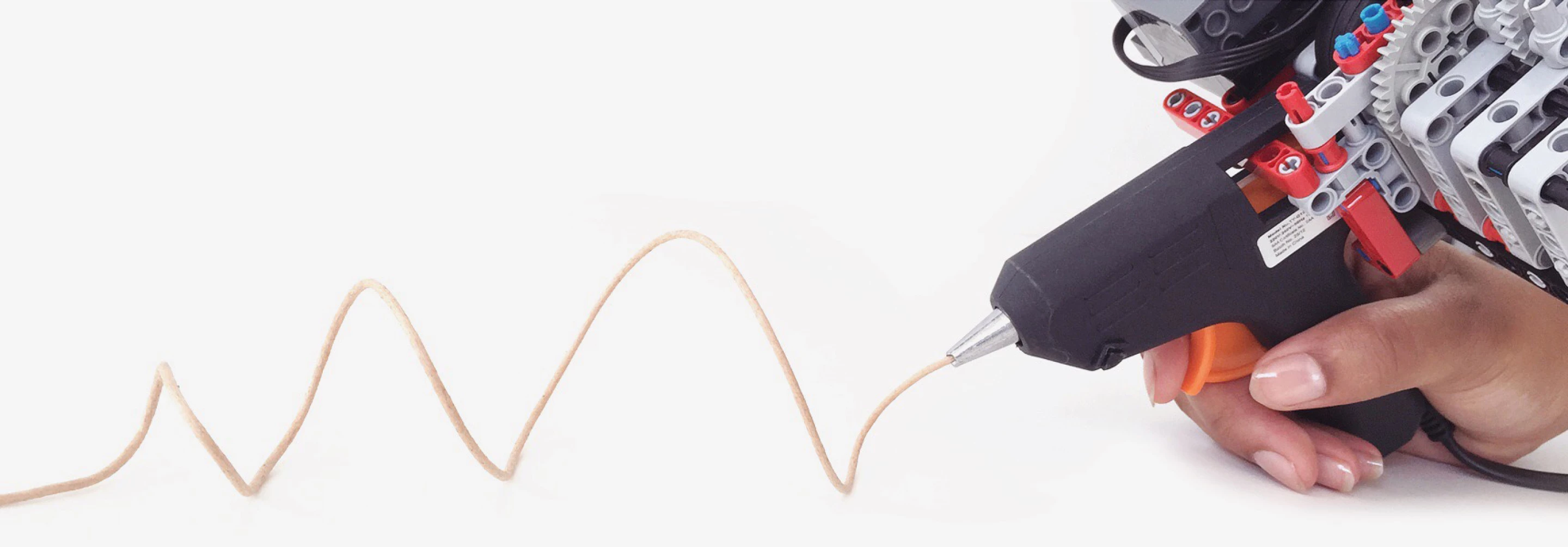 Hot glue gun becomes handheld 3D printer with some help from Lego