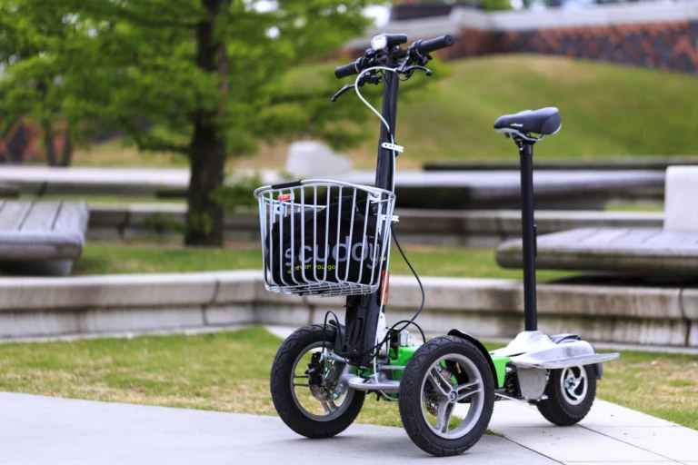 The Scuddy electric folding scooter stands up, sits down and trolleys