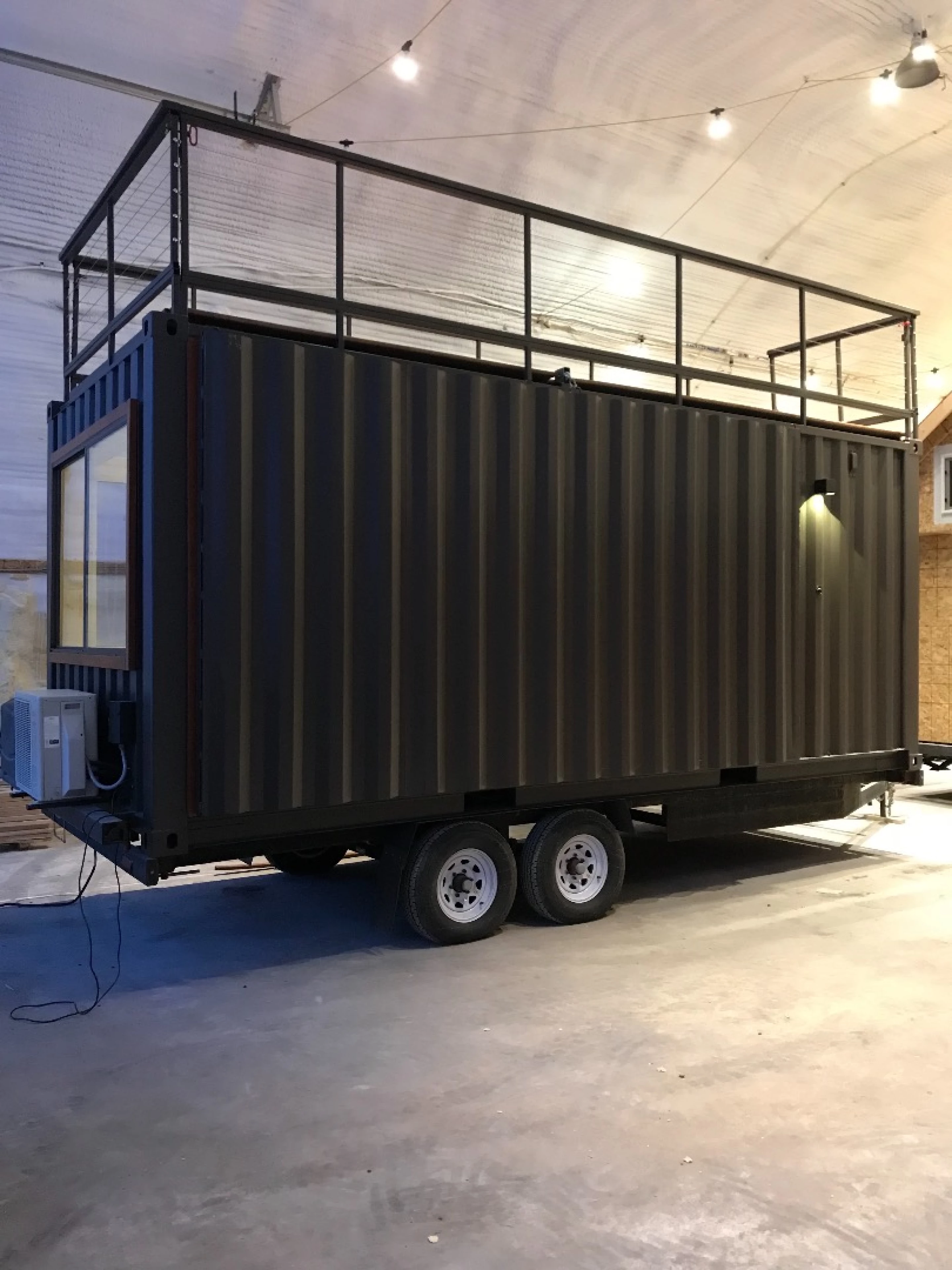 Shipping container-based tiny house can be towed or stowed
