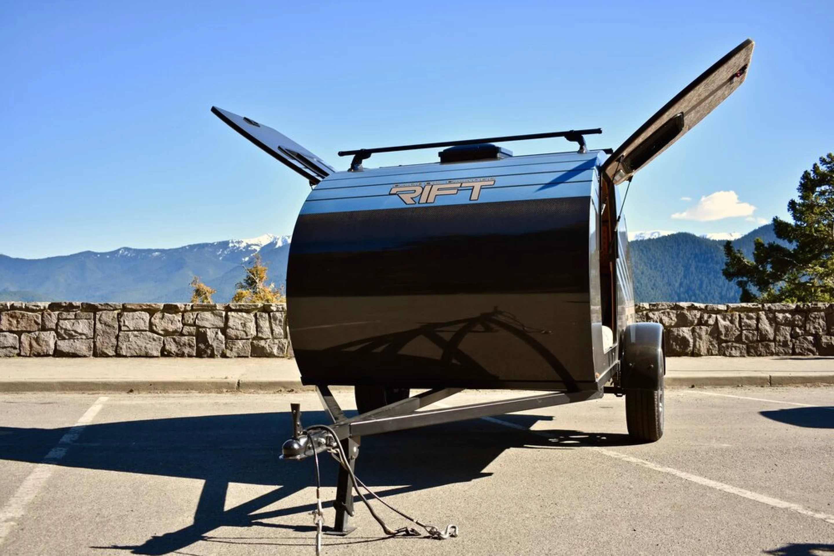 Ultralight carbon teardrop utility camper tows via EV or motorcycle