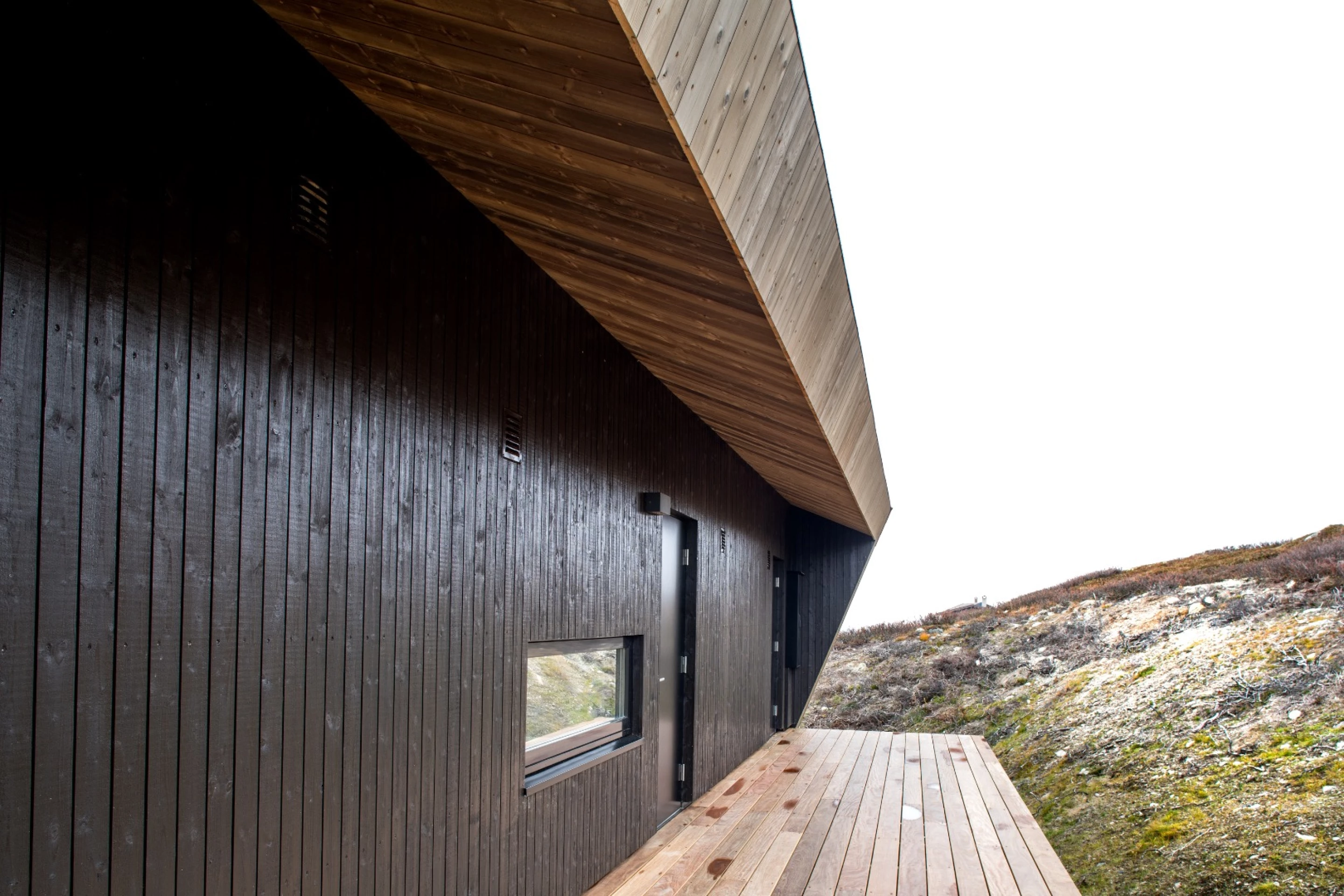 Remote mountain cabin's hood offers protection from the elements