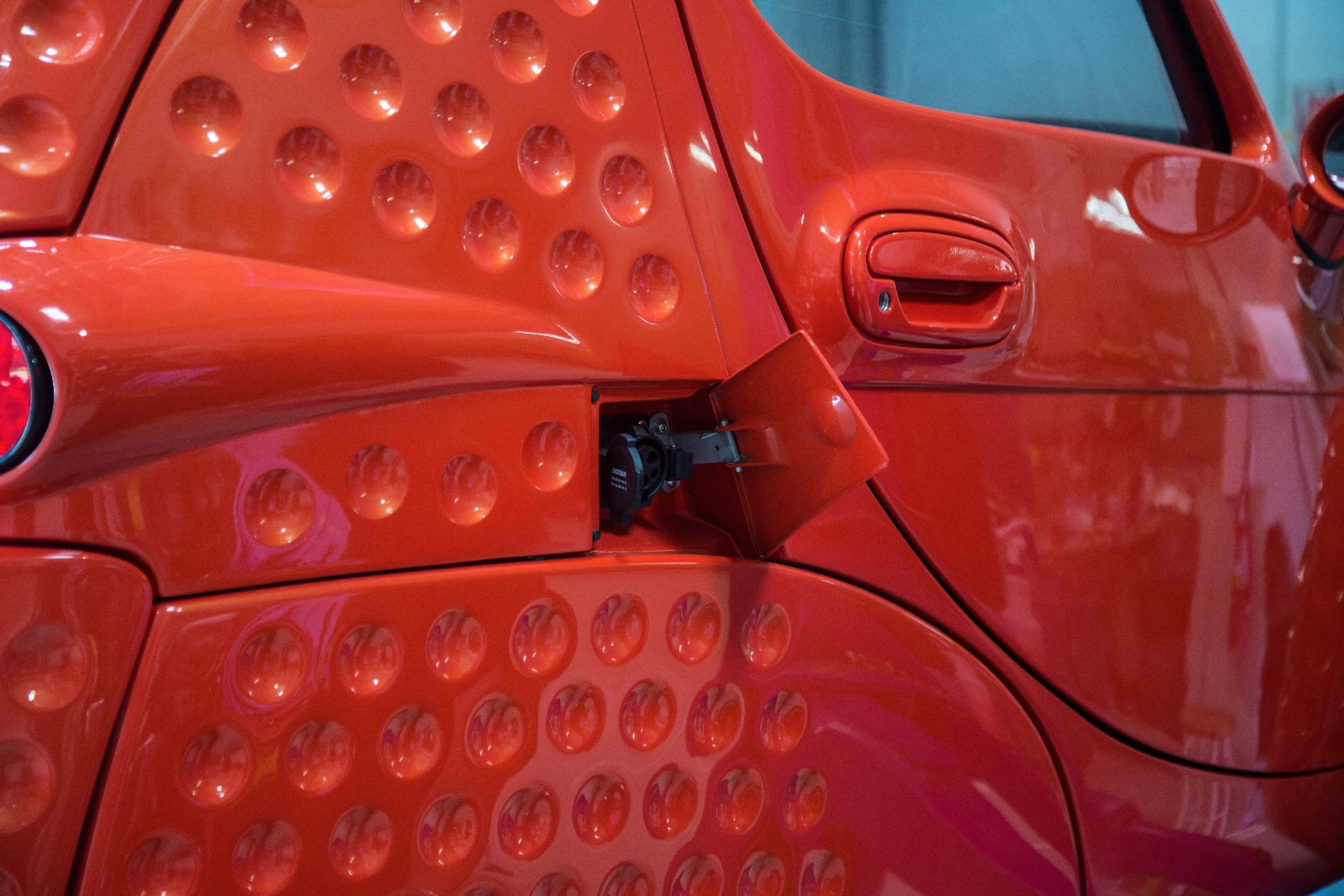 Corbin Sparrow electric three-wheeler, now with dimpled backside
