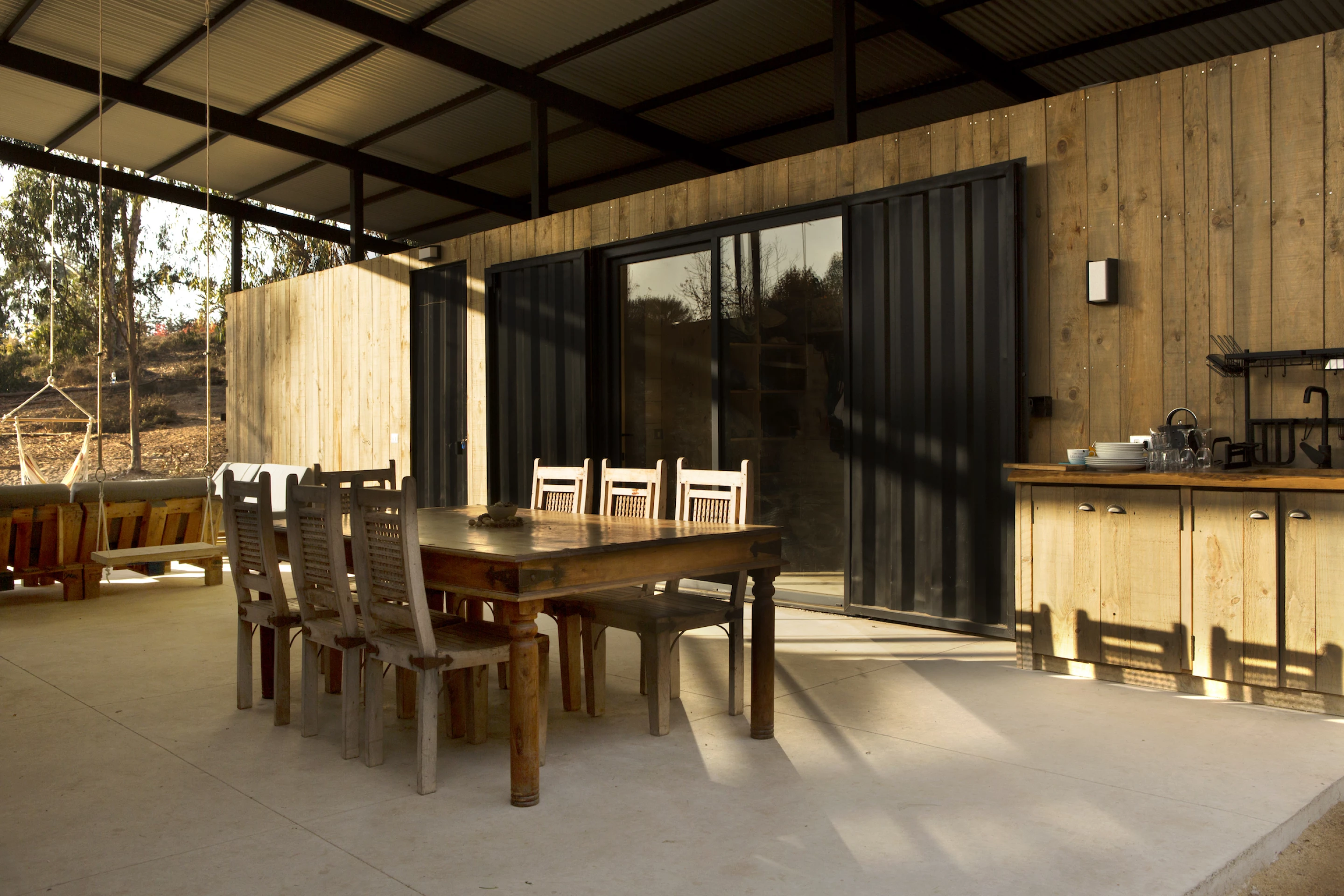 Shipping container home increases living space with sheltered exterior
