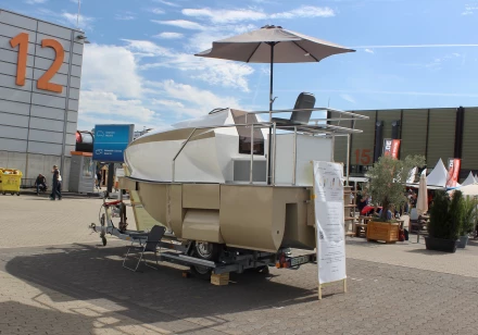 "Unsinkable" amphibious caravan flips wheels into hulls to float-camp