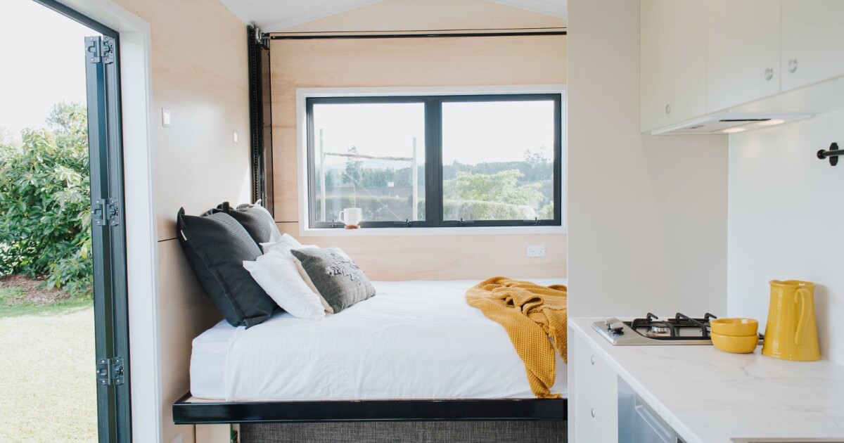 Compact tiny house makes space for four with novel pull-down bed
