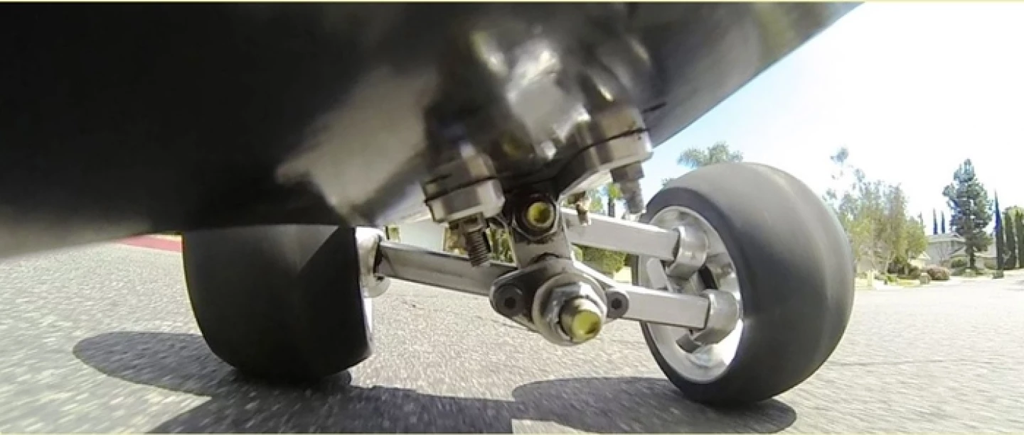 Lean Skateboard initiates sure turns with tilting, multi-link wheels