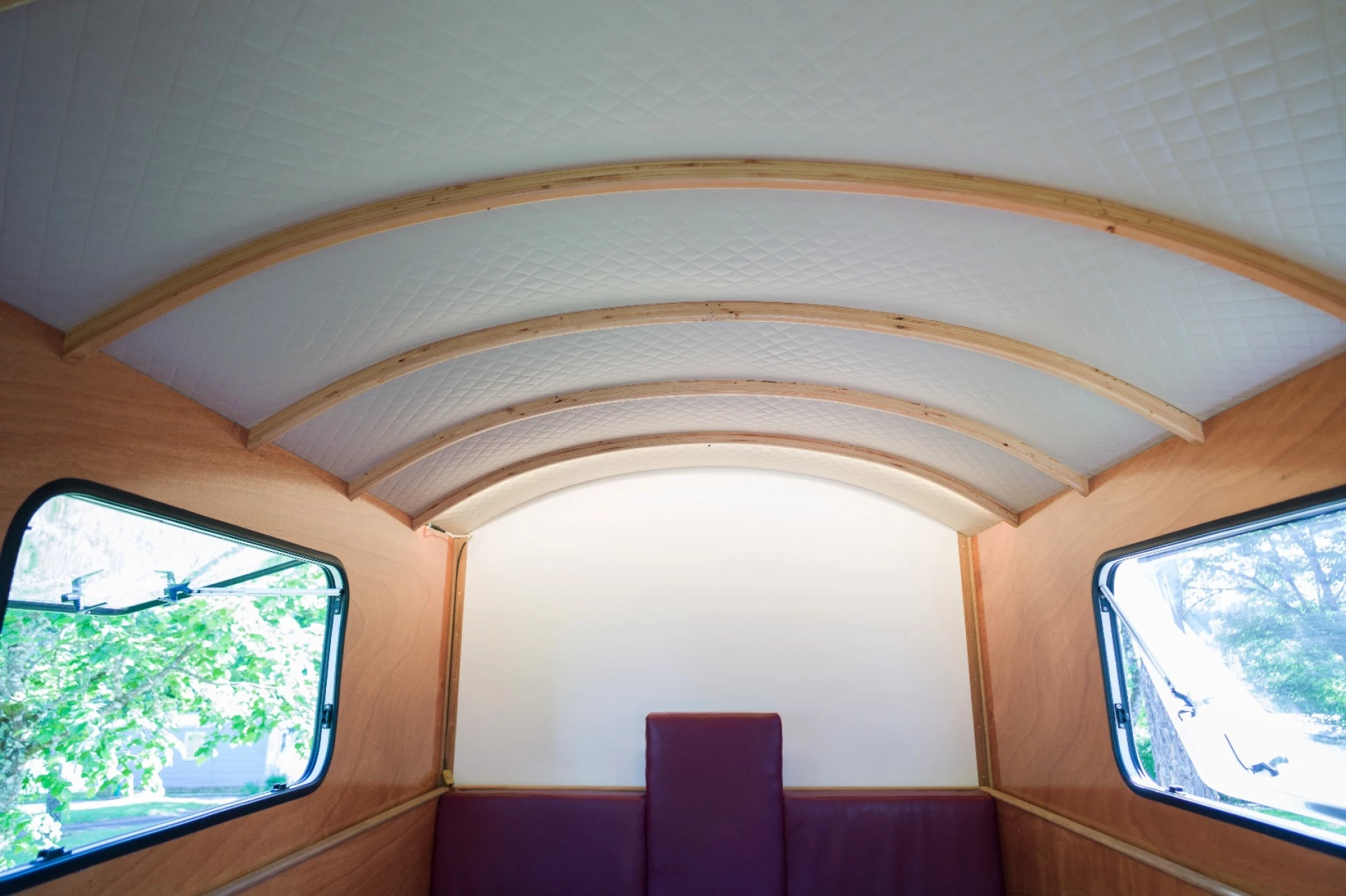 Telescoping wooden caravan raises the roof on small living