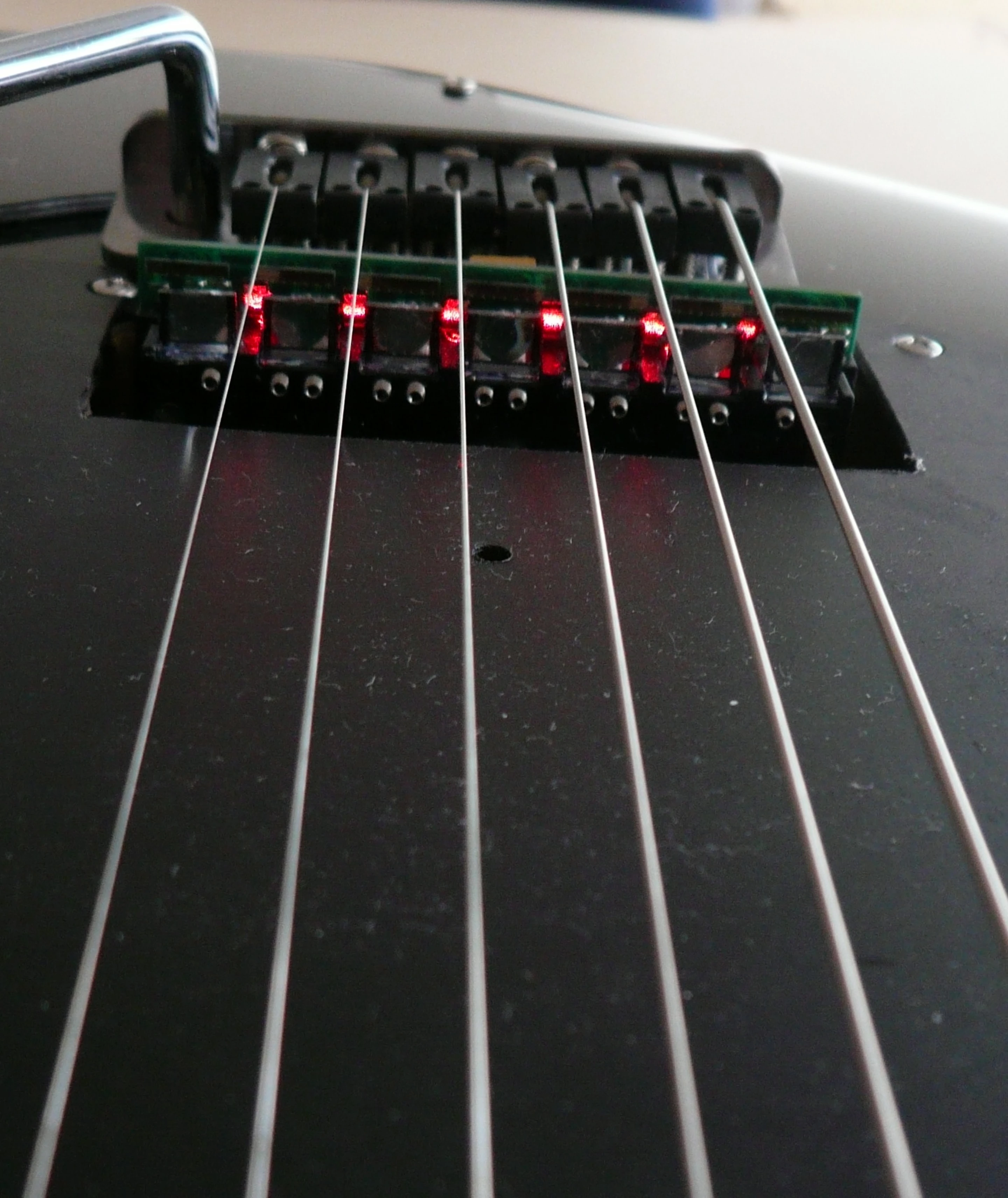 System uses lasers to detect the pitch of a guitar string before a note ...