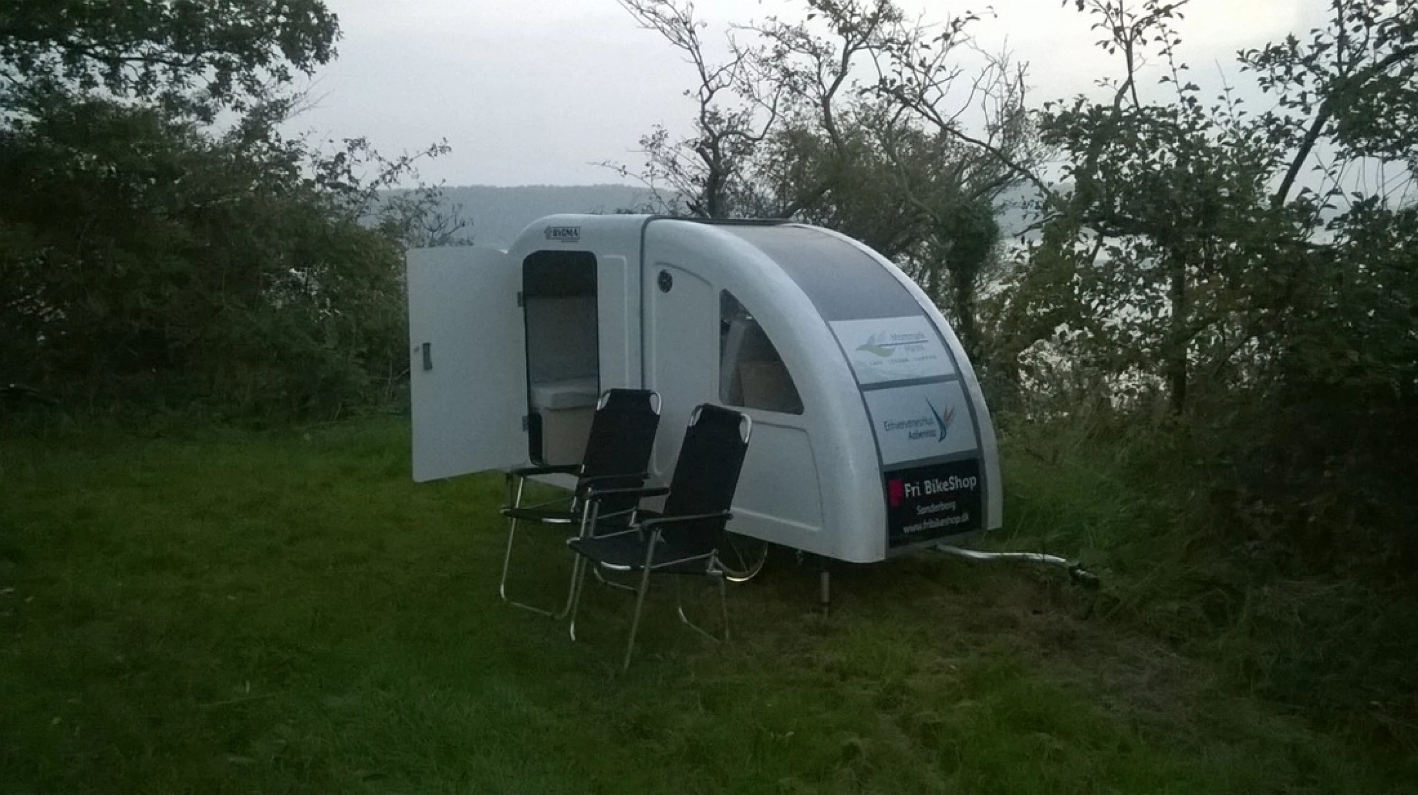 Lightweight caravan sleeps two adults, is towed by bicycle
