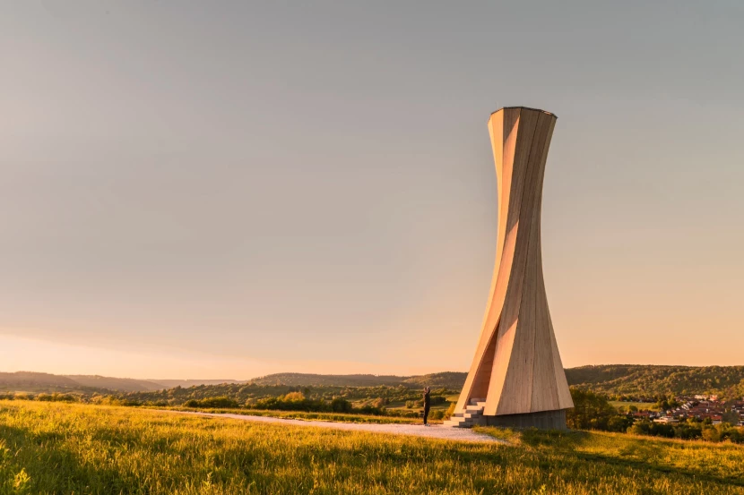 "World-first" twisting tower is made from timber that bends itself into ...