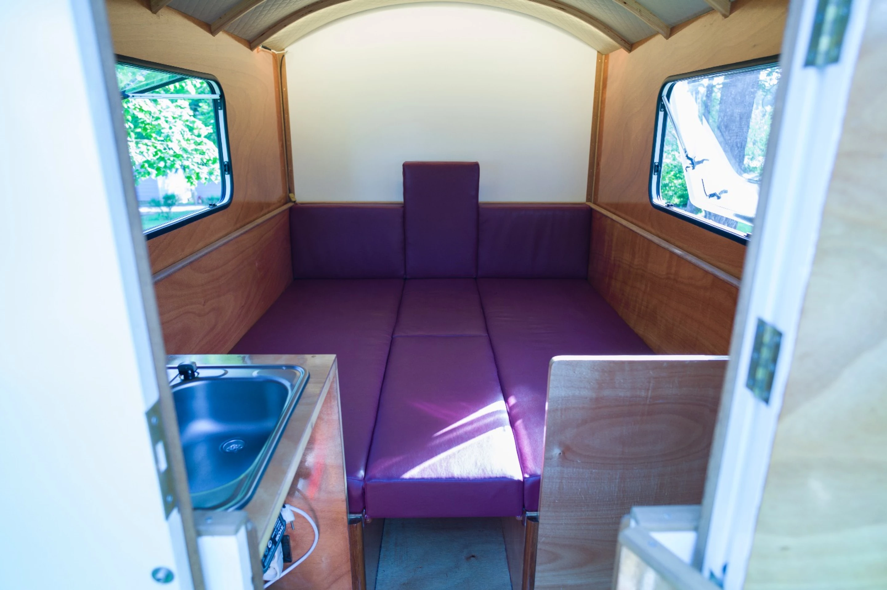 Telescoping wooden caravan raises the roof on small living