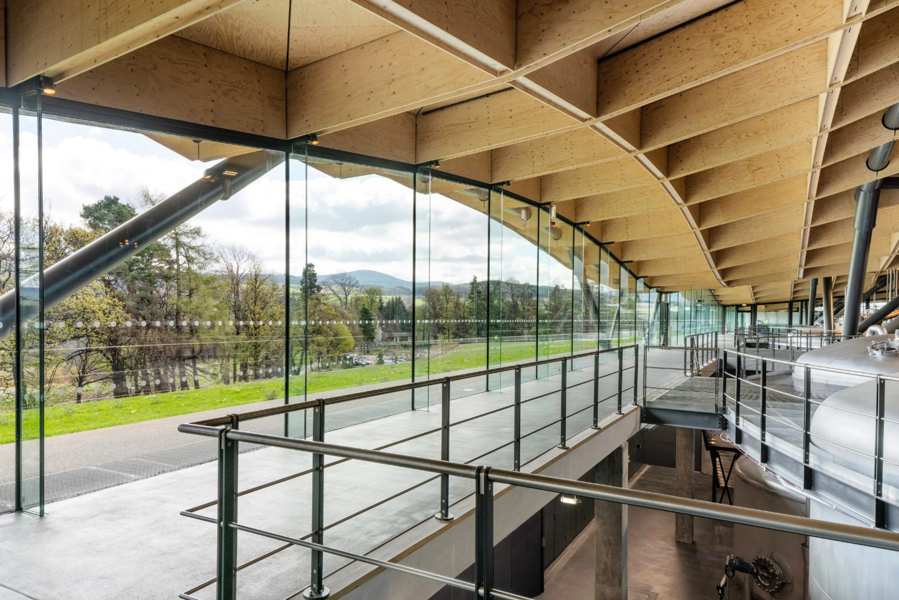 Scottish whisky distillery blends into the landscape with undulating ...