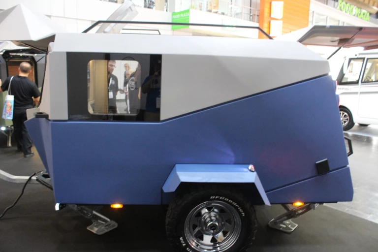 Gull-wing mini-caravan brings color and edge to the road less traveled
