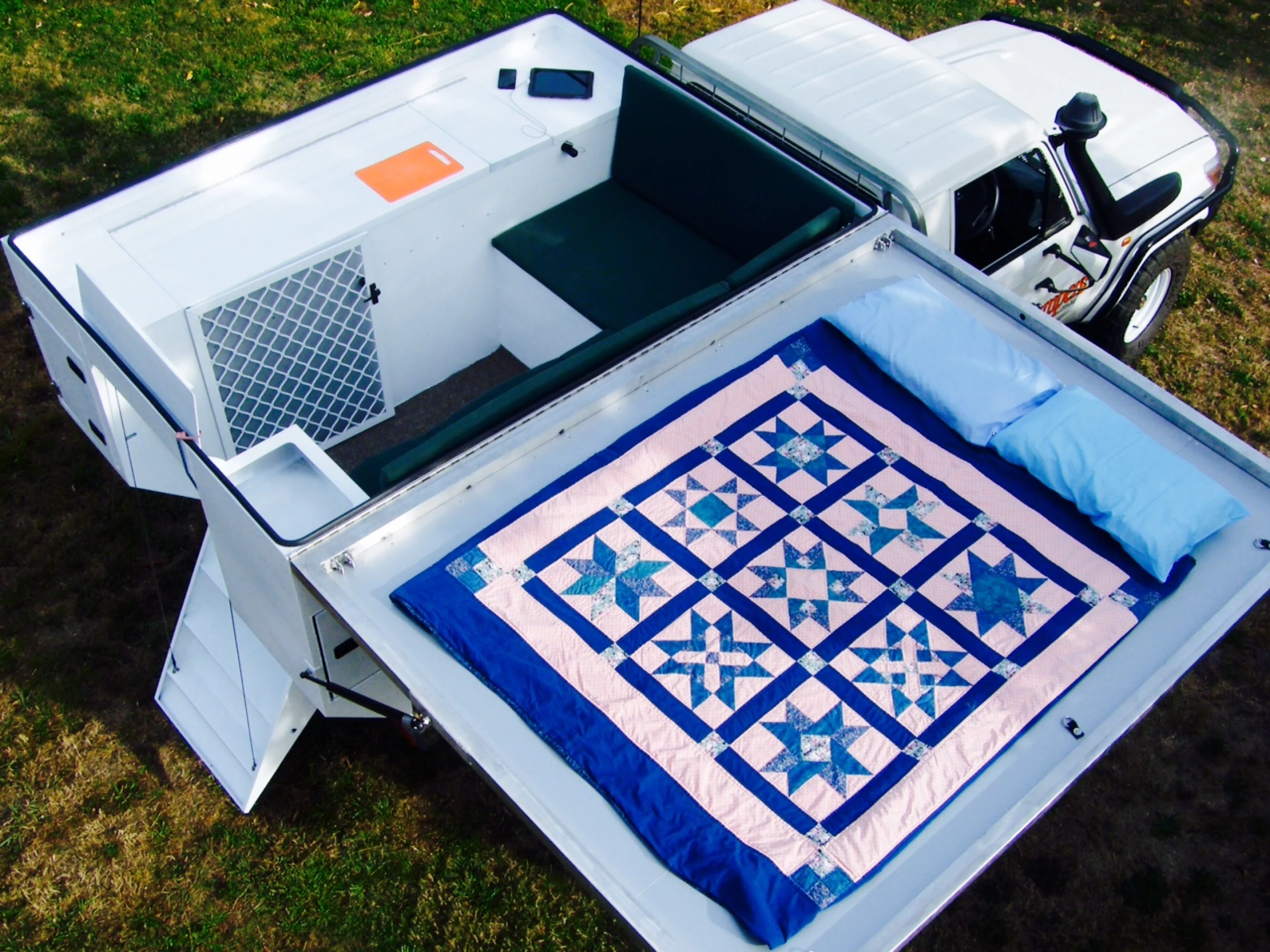 Gecko camper flips and folds to make your truck home