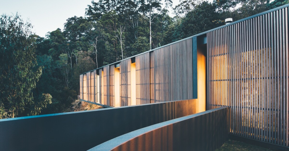 Timber screens shield glass house from summer sun