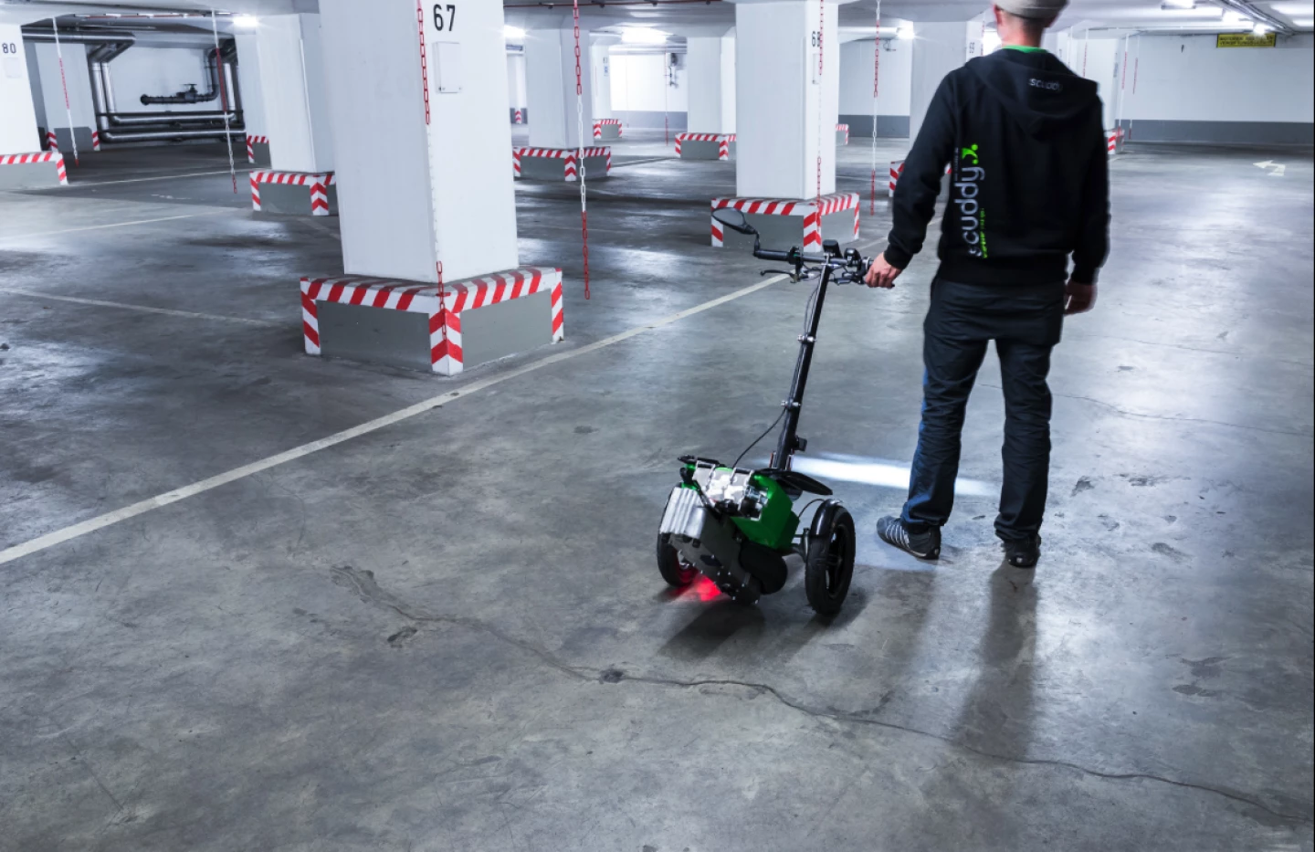 The Scuddy electric folding scooter stands up, sits down and trolleys