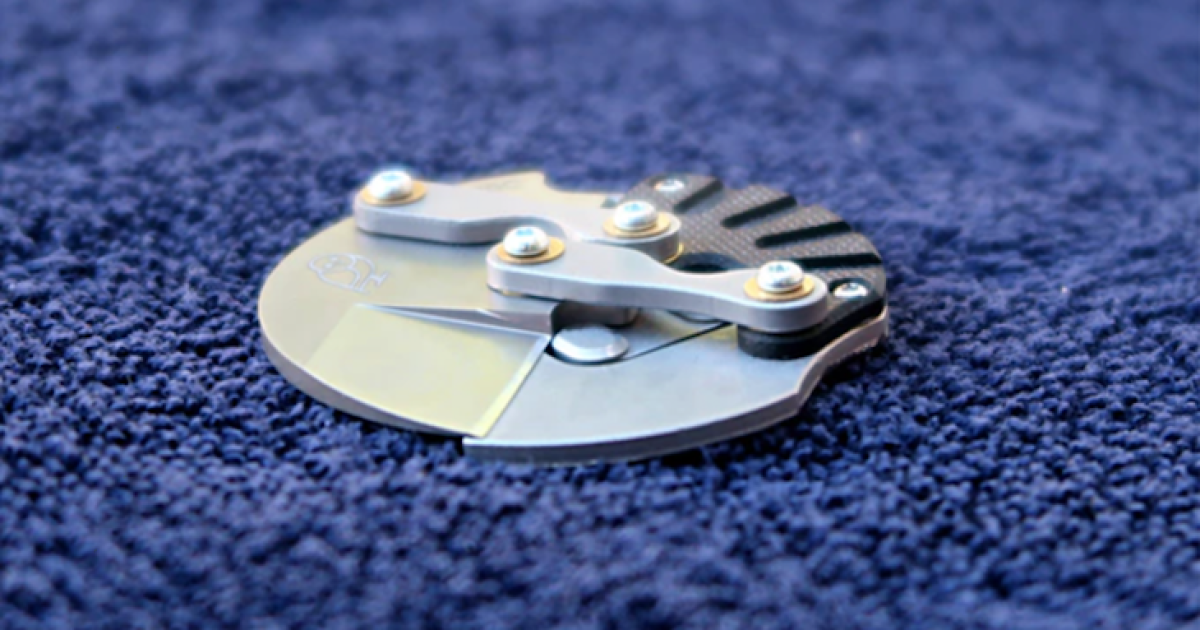 Coin-shaped pocket knife snaps into action