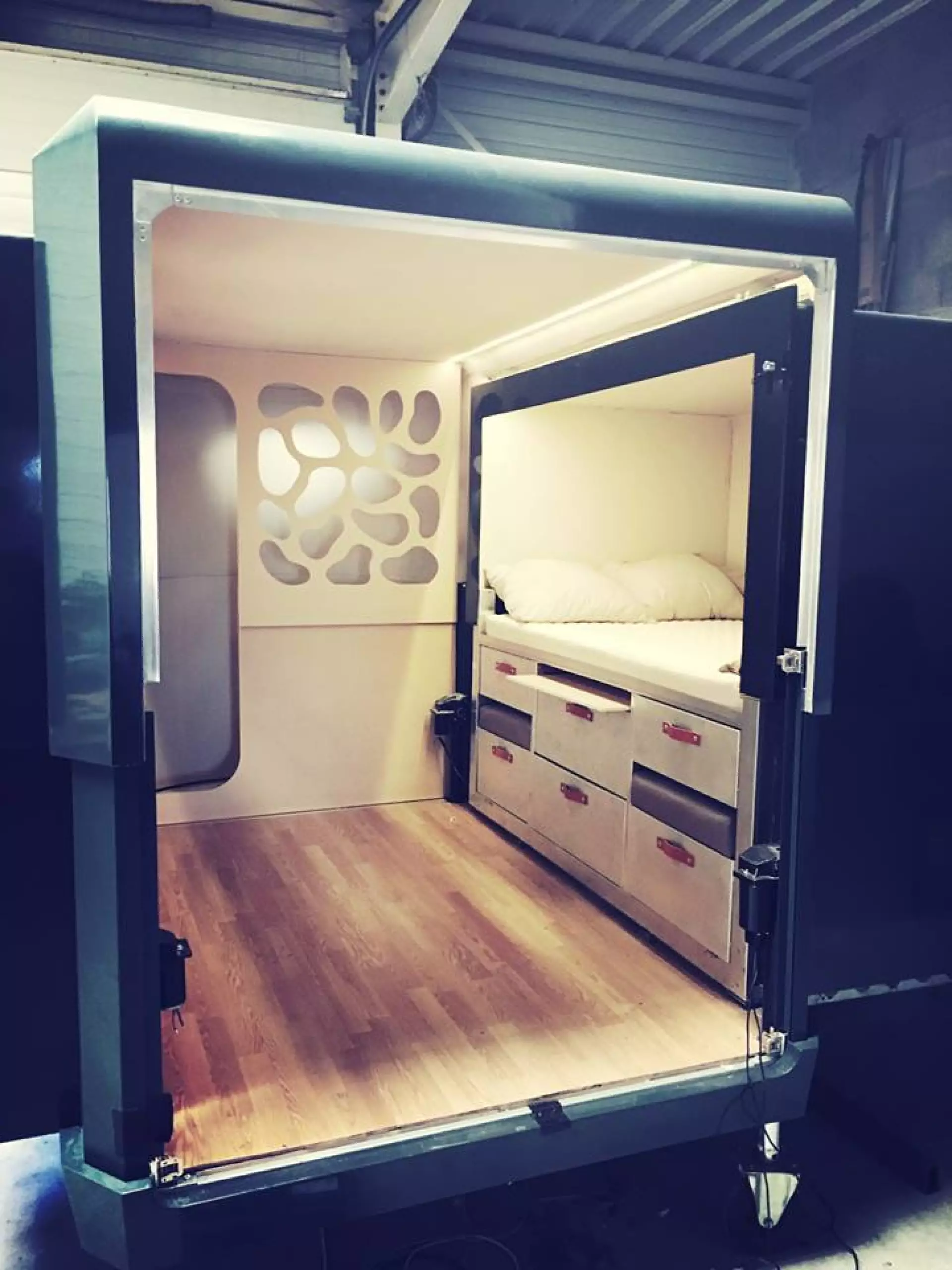 Sleek, compact camper pod grows to 3 times its size at the push of a button