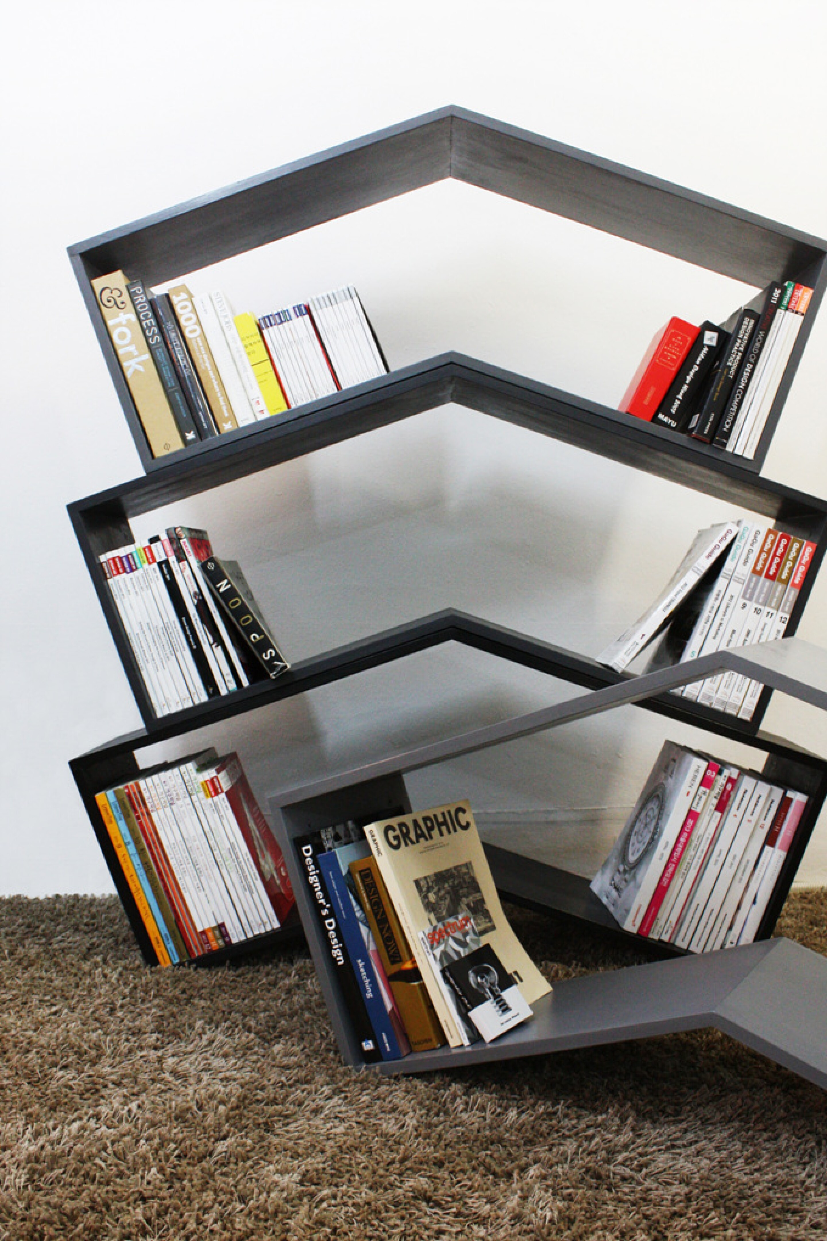Elegant angled bookshelf needs no bookends