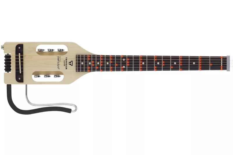 Follow-the-lights learning system installed on travel guitar
