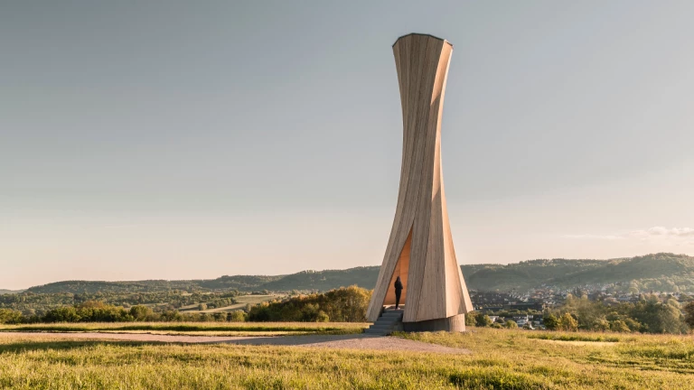 "World-first" twisting tower is made from timber that bends itself into ...