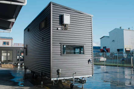 Compact tiny house links its lofts and opens up to the outside