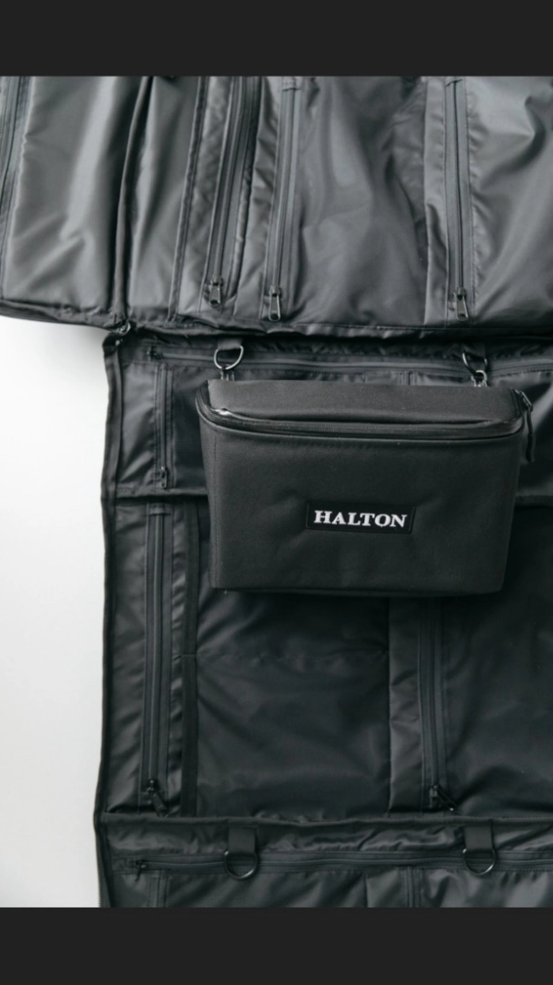 Commuter backpack unfurls into a hanging organizer via a single zip